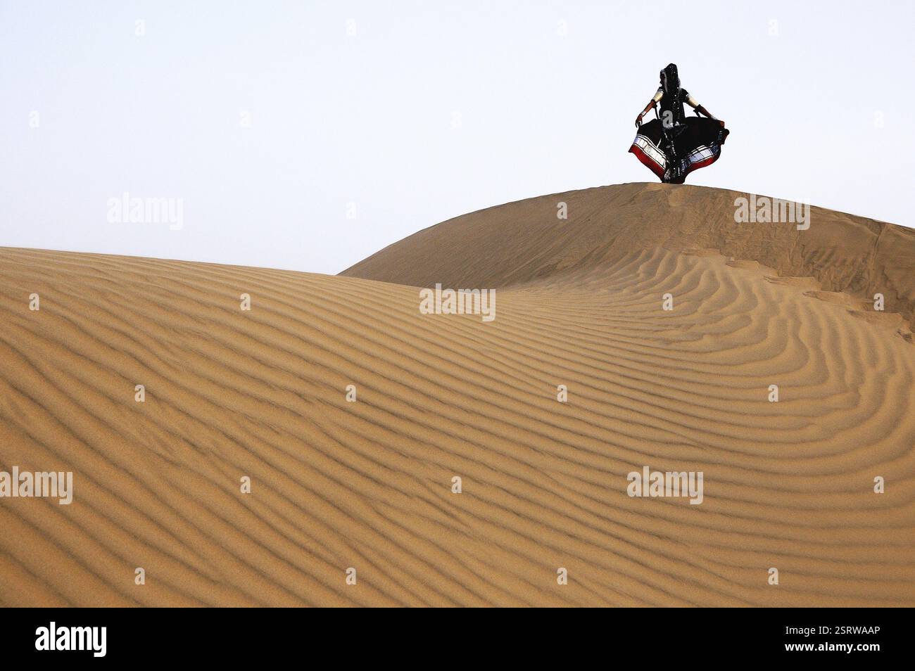 Rajasthani lady walking through sand dunes, Jaisalmer, Rajasthan, India ...