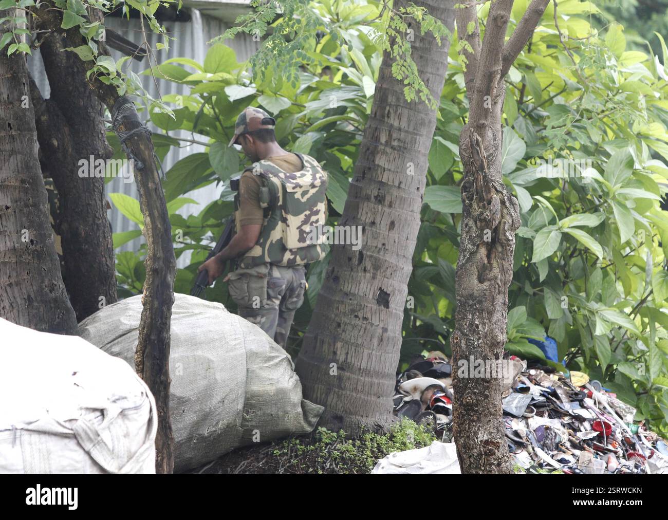 A Force One commando conducts a search and combing operation in a slum ...