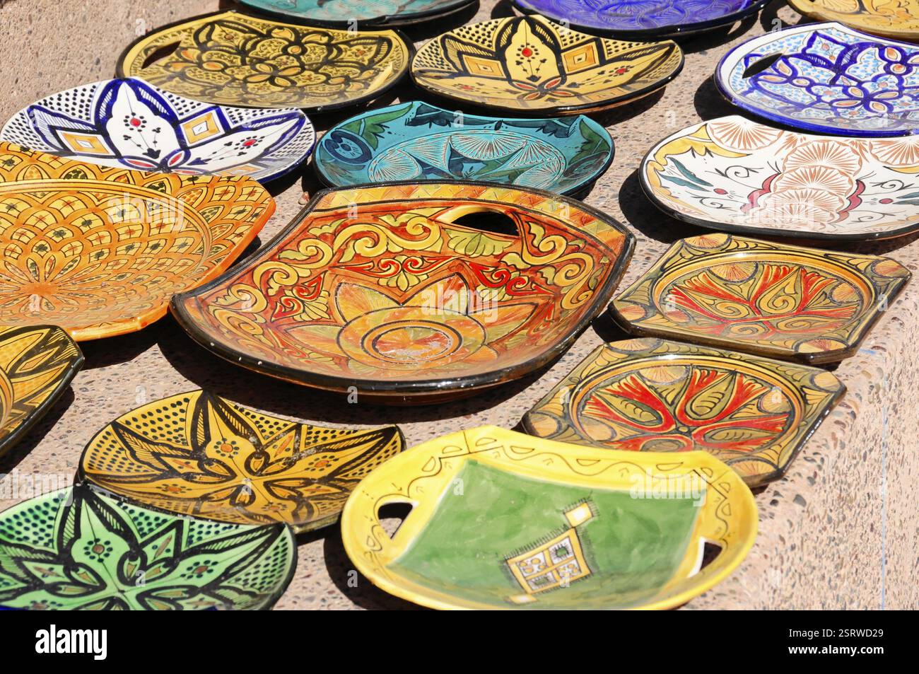 Different coloured, artistically painted ceramic bowls with traditional ...