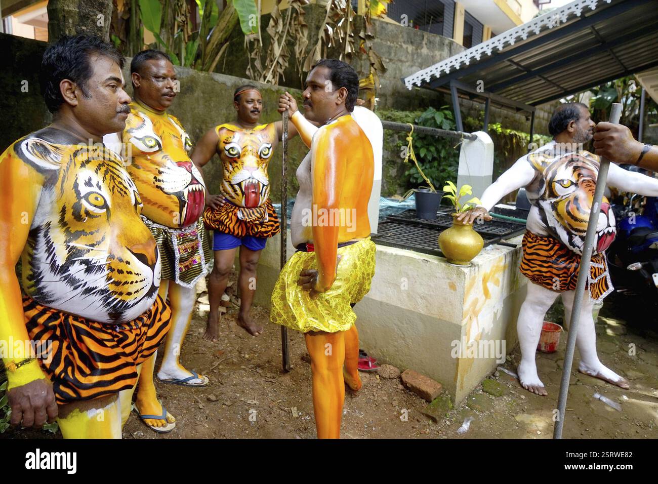 Trained dancers get their body painted in the colours of a tiger prepare to participate famous ...