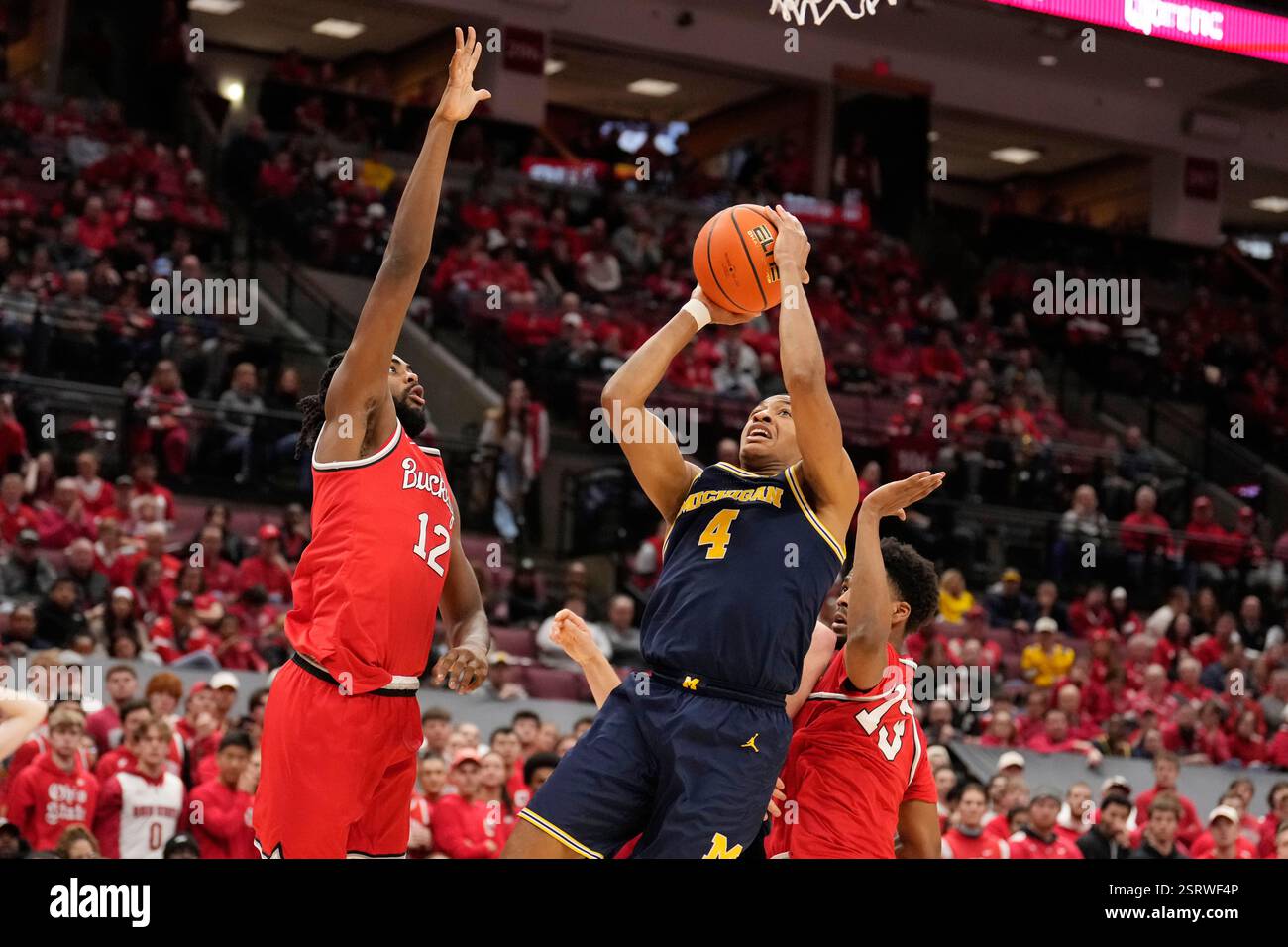 Michigan guard Nimari Burnett (4) shoots between Ohio State guard Evan ...