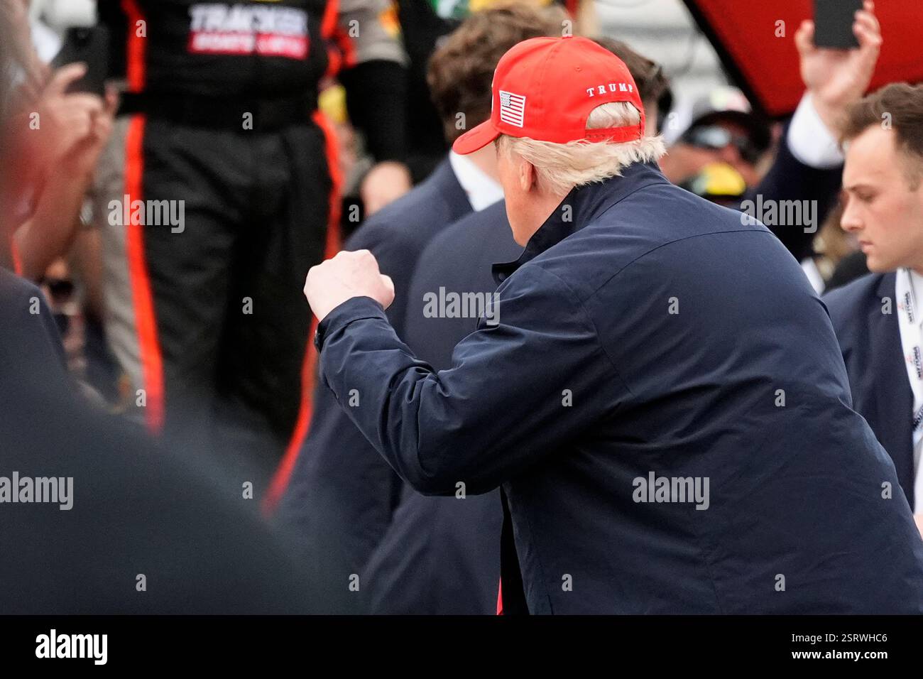 President Donald Trump gestures to the crowd at the NASCAR Daytona 500 ...