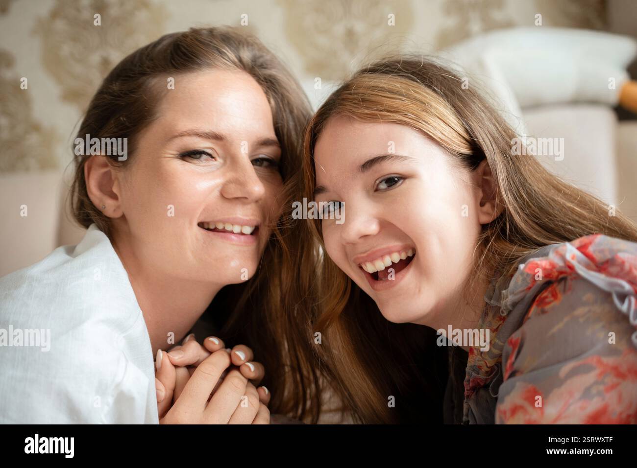 Sisters Happiness Portrait Indoor: Two smiling sisters pose closely for ...