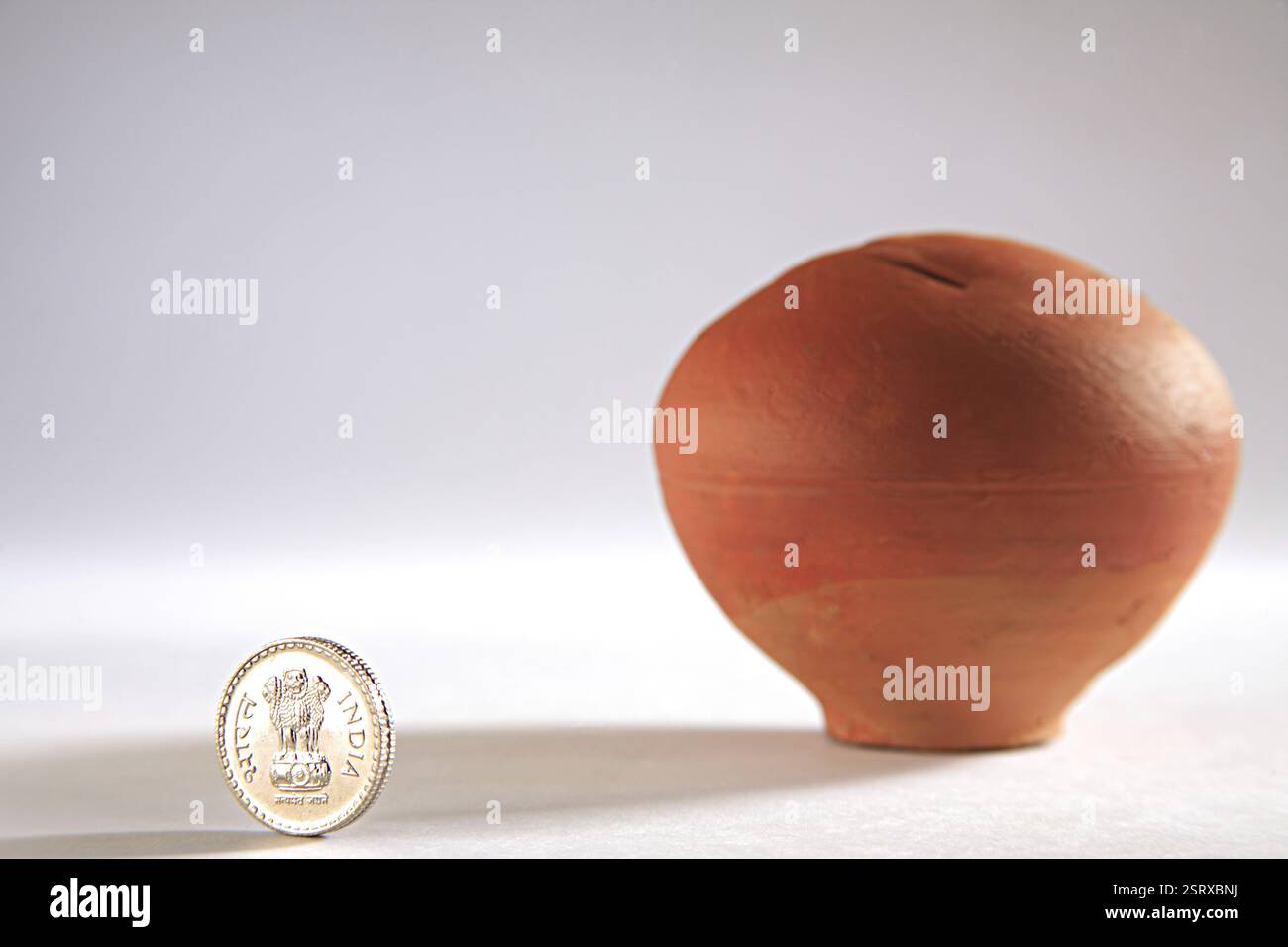 Concept, gullak clay bag or box for keeping wealth with coin on white ...