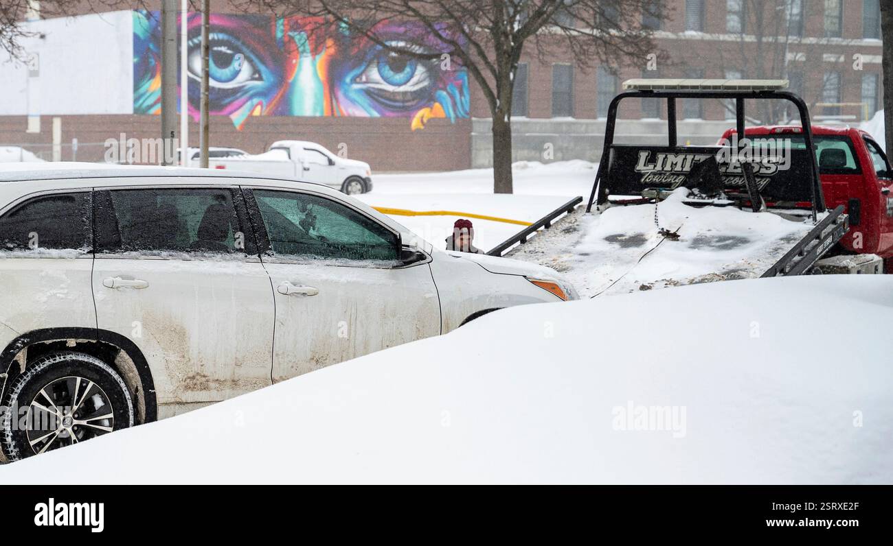 Adam O'Neil, from Limitless Recovery and Towing hooks up a vehicle ...
