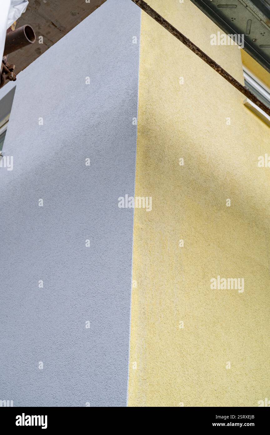 A closeup of a building's corner, featuring a sharp contrast between ...