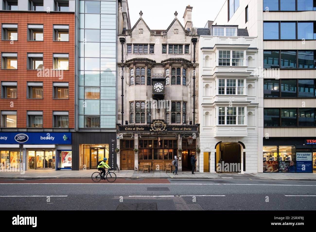 Cyclist on High Holborn, London, near the historic Cittie of Yorke pub ...
