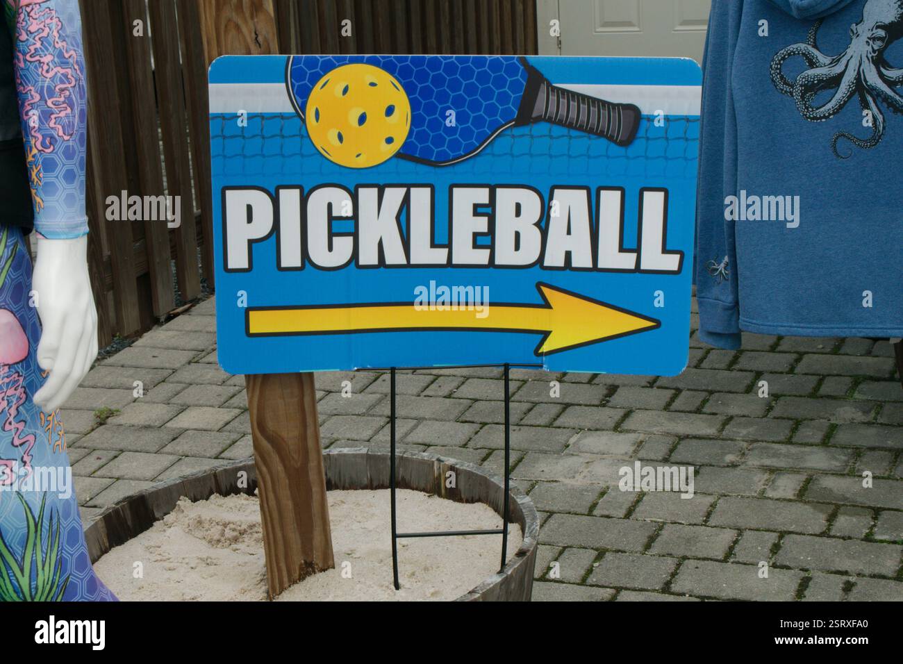Pickleball sign with an arrow to the right, ball and paddle. Blue ...