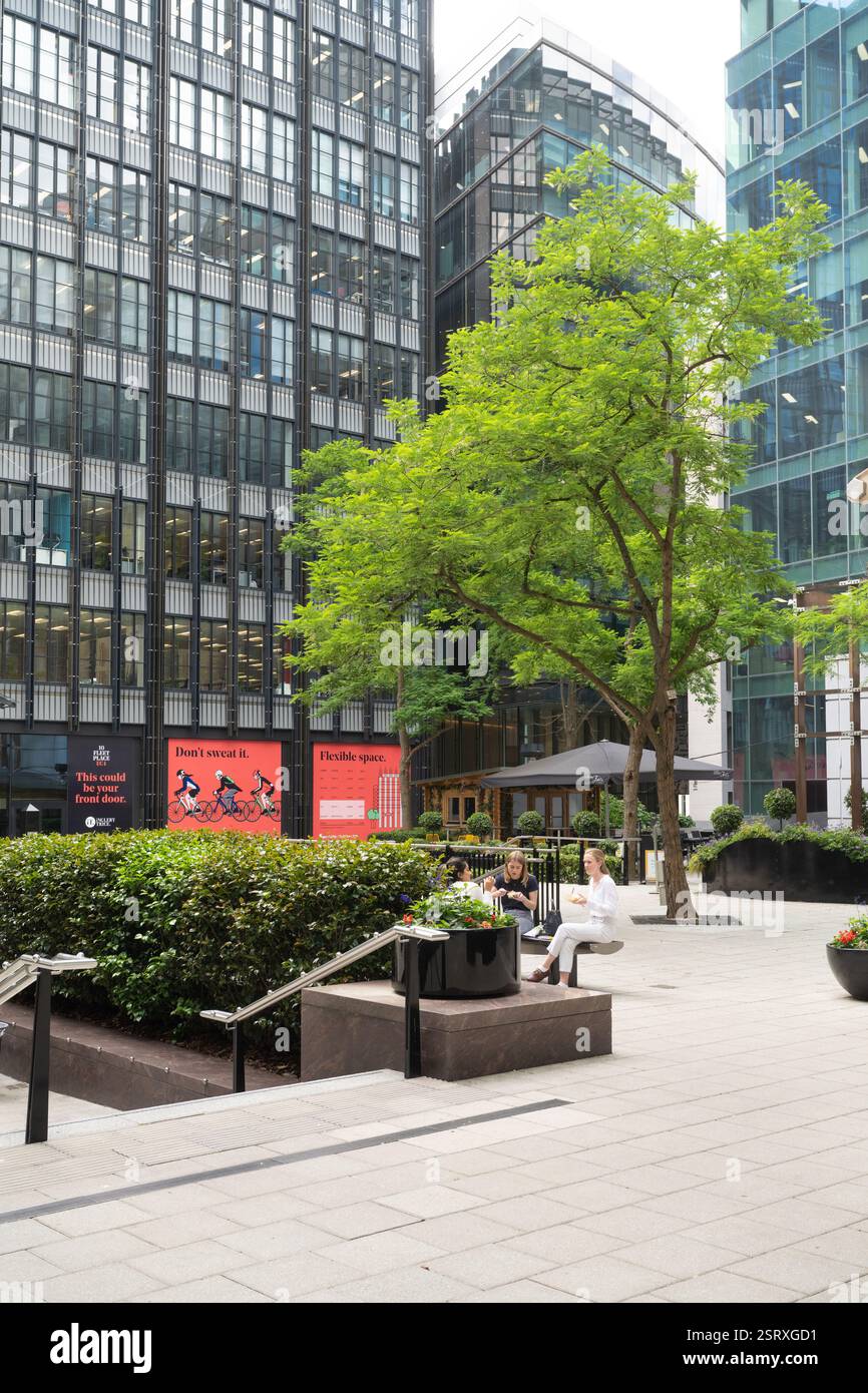 Pedestrians enjoy lunch at a plaza outside 10 Fleet Place, EC4, London ...