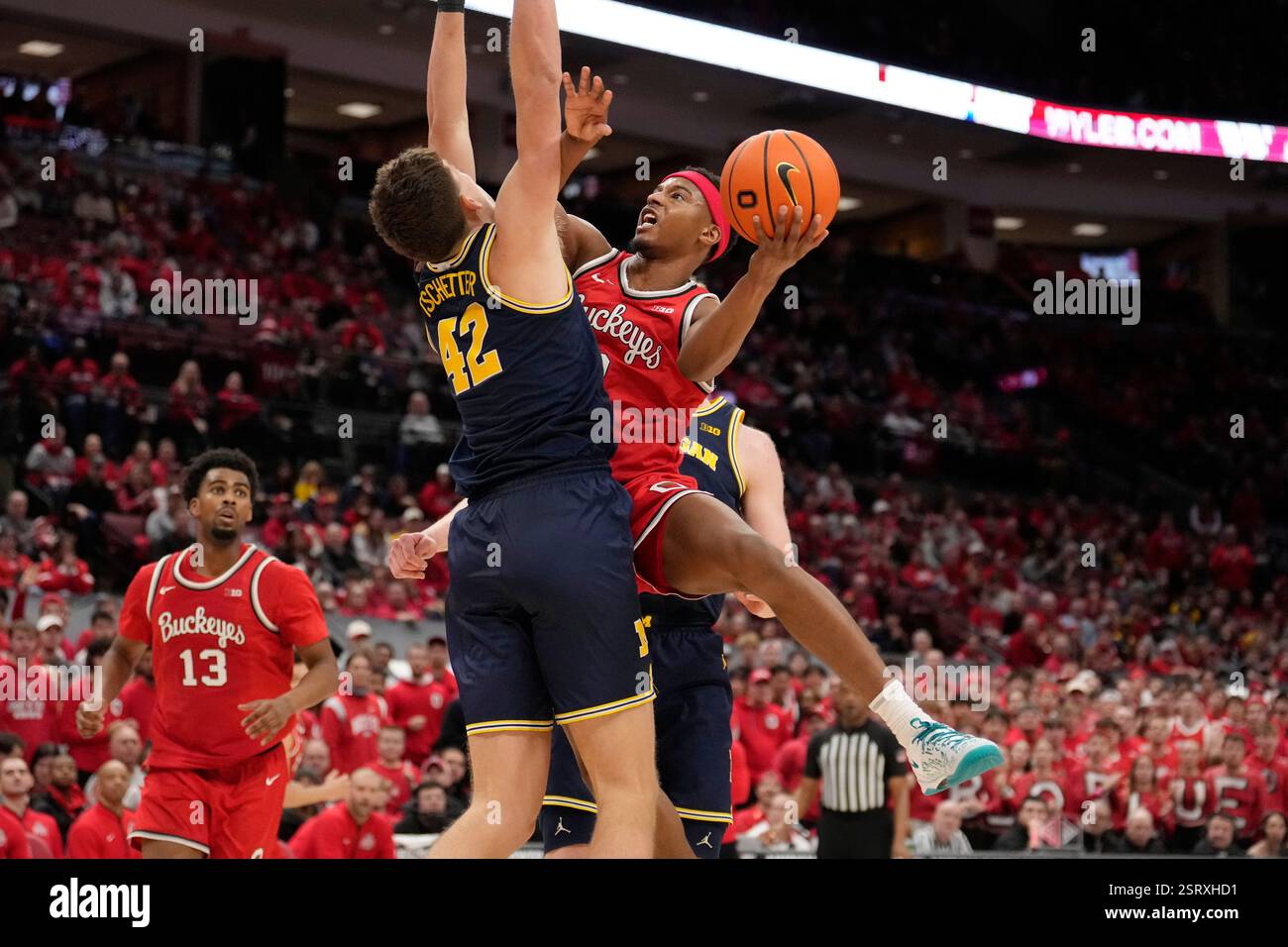 Ohio State guard Micah Parrish, right, shoots as Michigan forward Will Tschetter (42) defends in ...