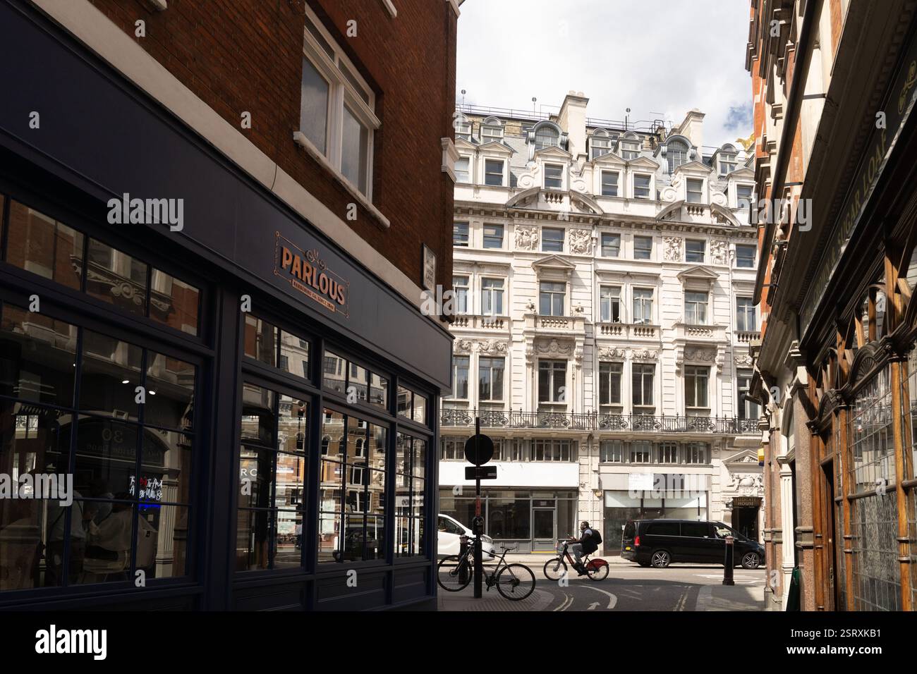 A cyclist rides past Parlous, a barbershop in Bride Lane, London, near ...