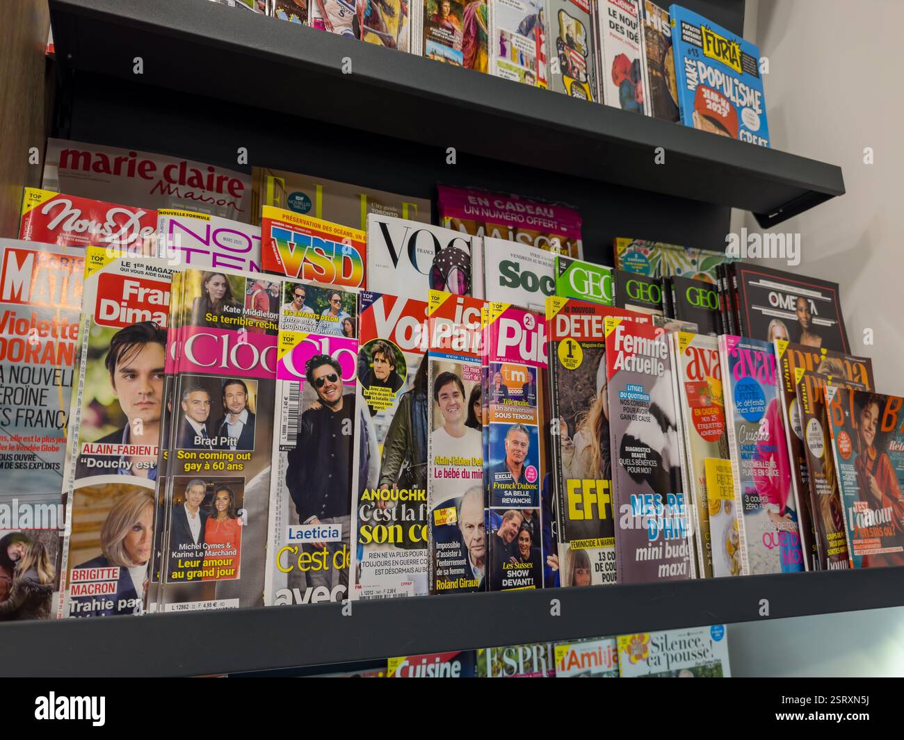 Colorful array of magazines displayed on shelves in a modern cafe Stock ...