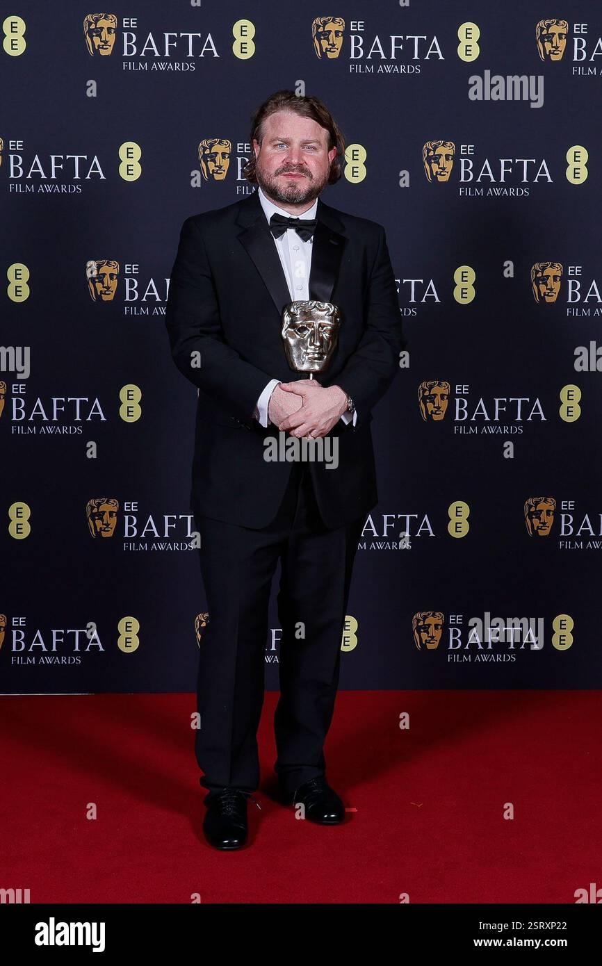 Brady Corbet poses with the award for best director for "The Brutalist ...
