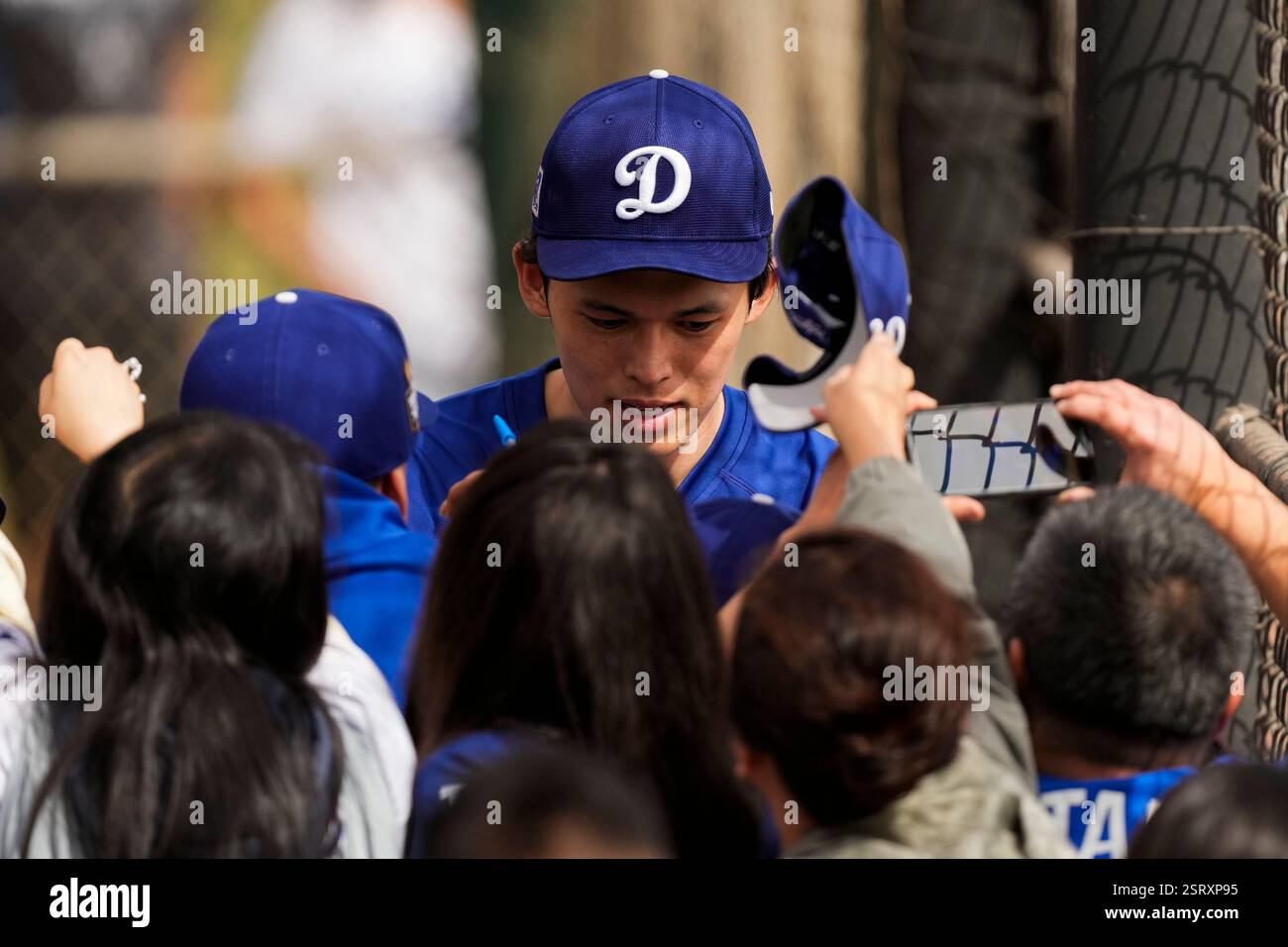 Los Angeles Dodgers pitcher Roki Sasaki sings autographs for fans ...