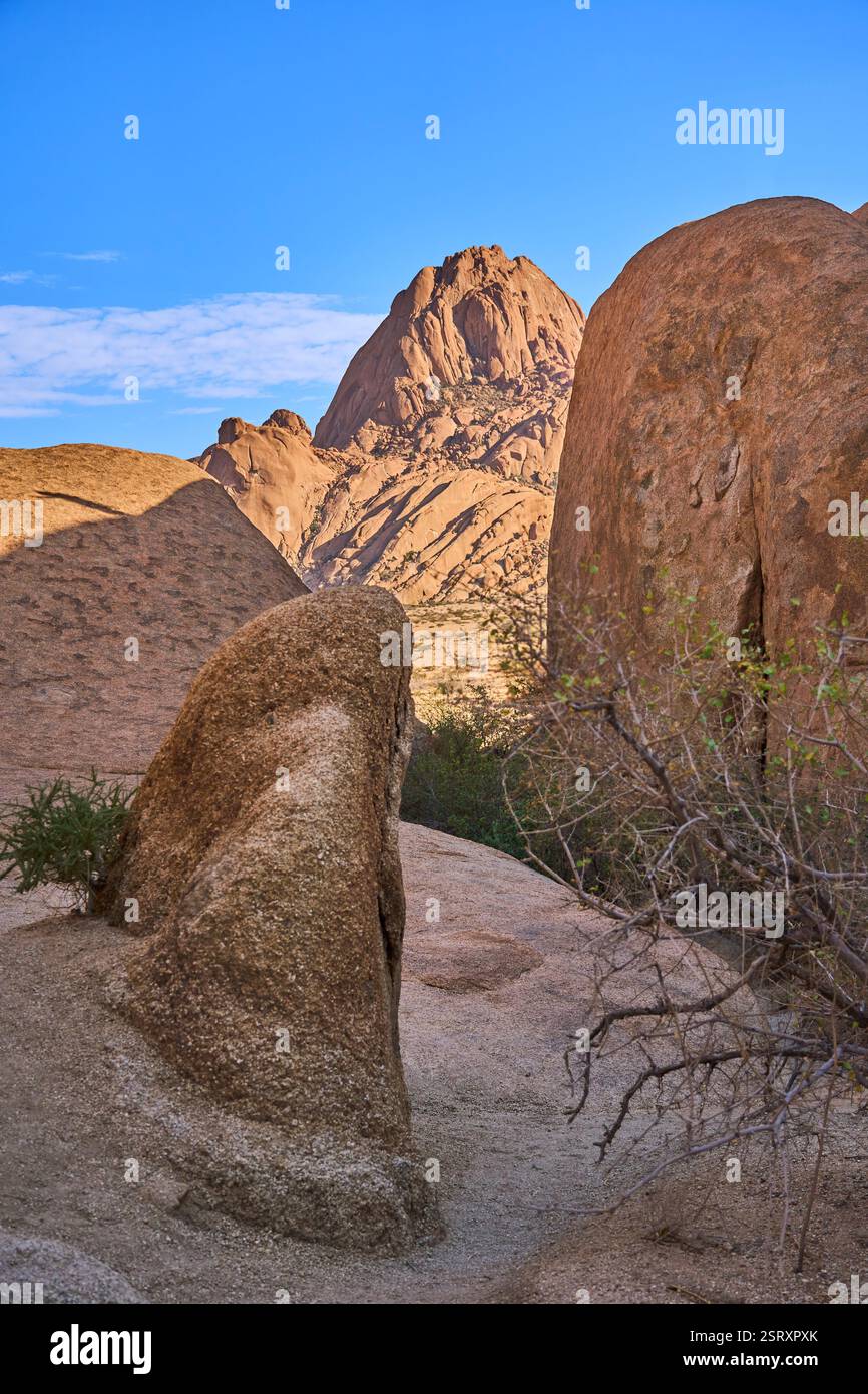 Spitzkoppe mountain is seen through the gorge between two boulders, in ...