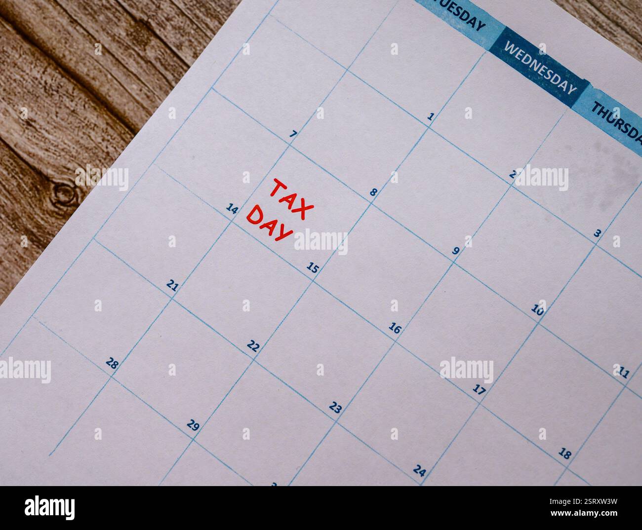 A calendar sheet displays the date marked in red as tax day, set ...