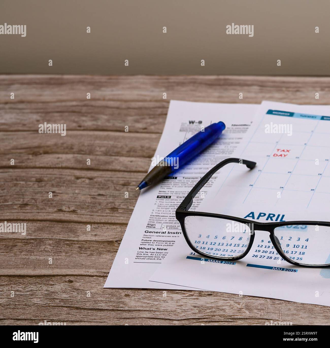 Important tax documents, a calendar marked for tax day, and a pen are ...