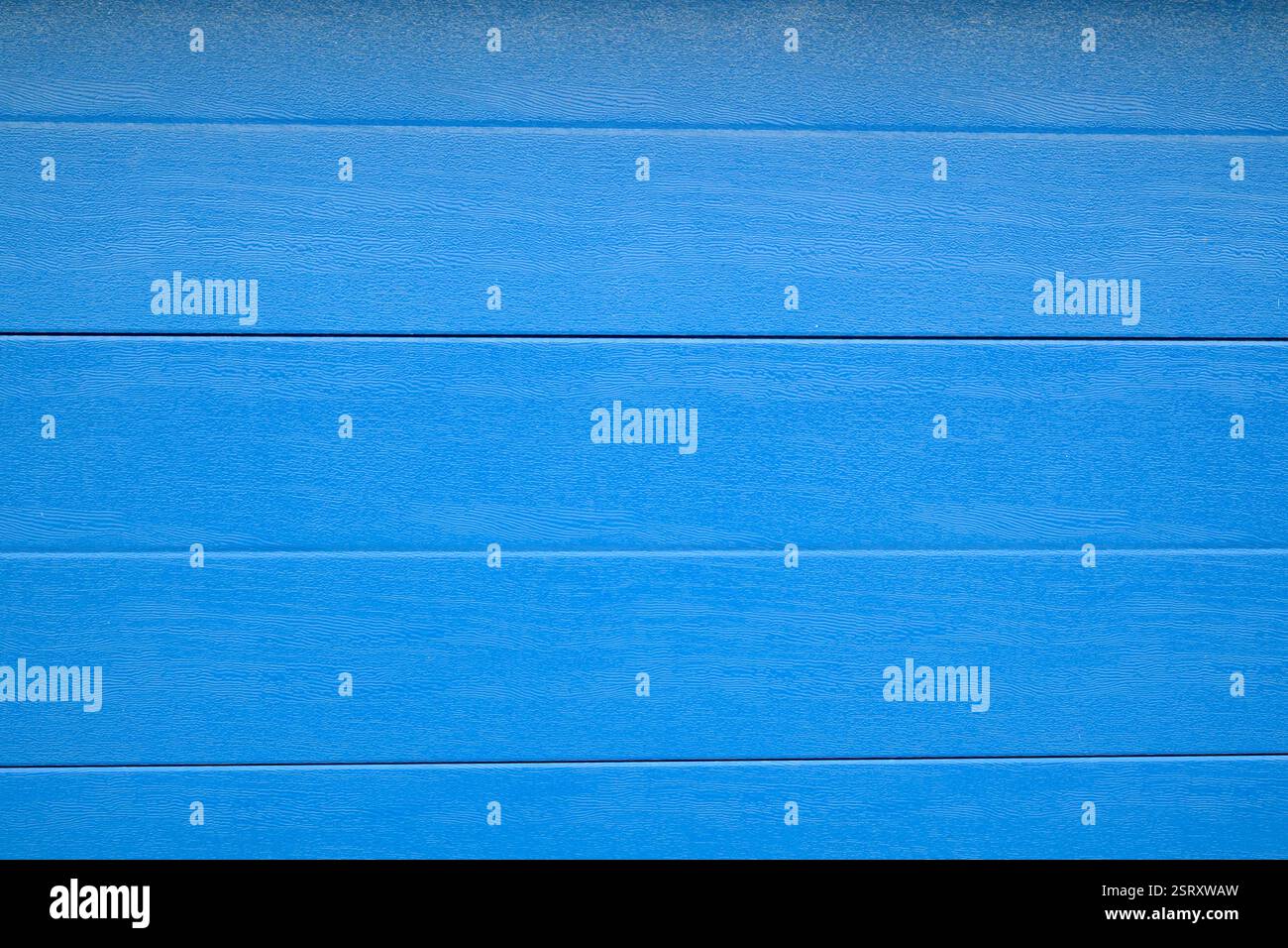 Vibrant blue wooden planks stretch across the surface, providing a ...