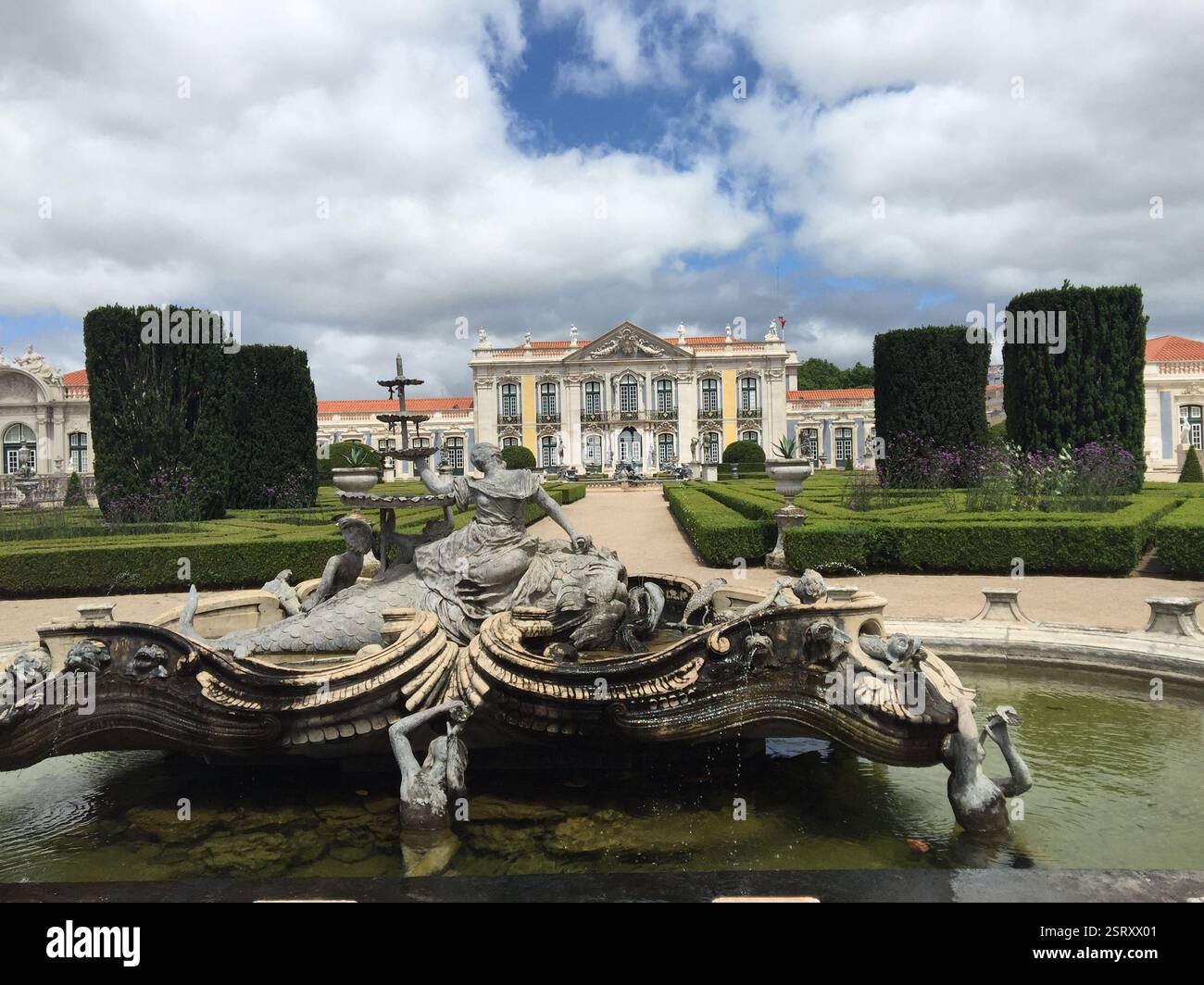Fountain in Portugal. Baroque-style fountain with sculpted figures and water jets. Central ...