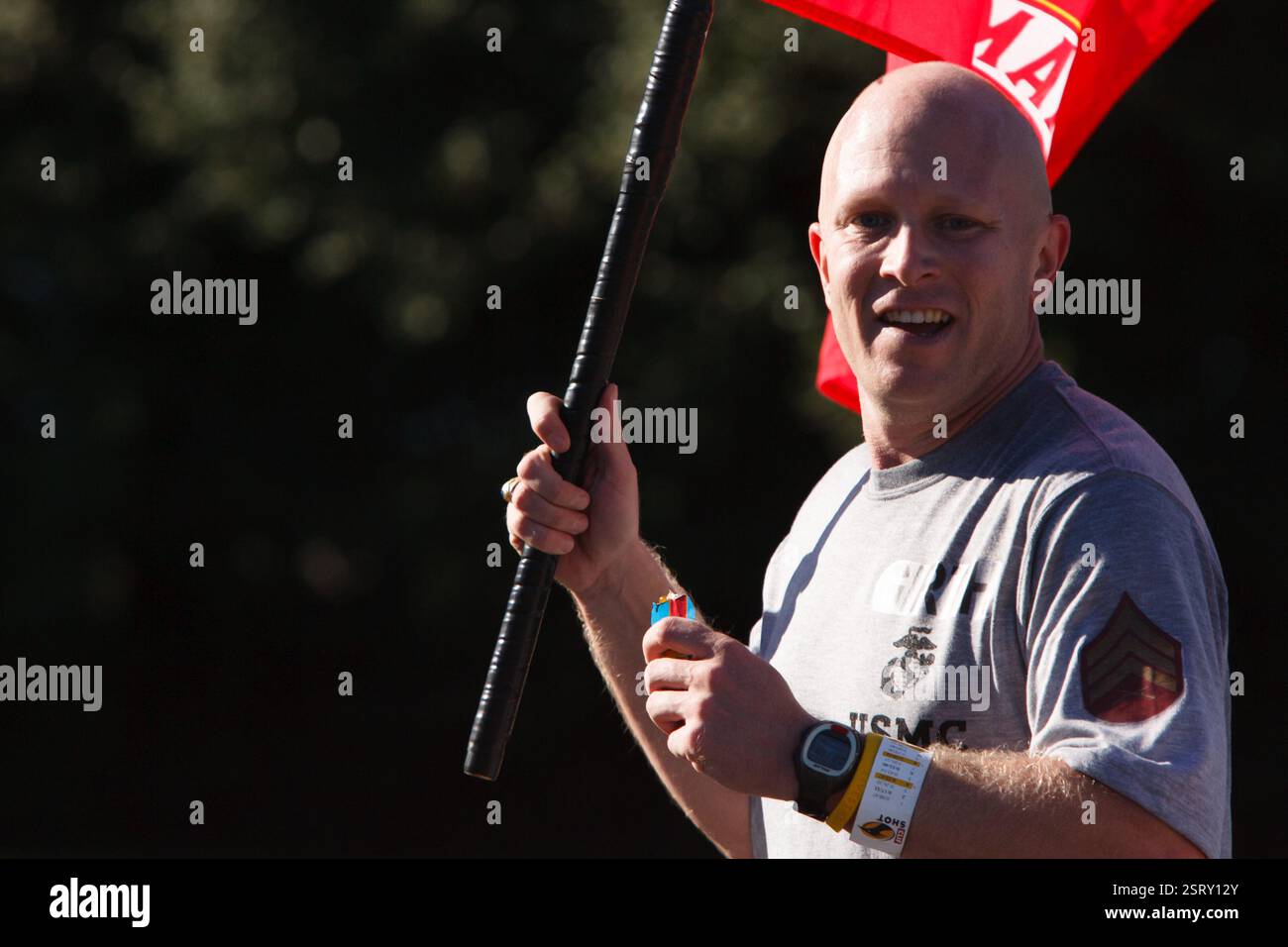 A runner participant holds a Marine Corps flag and gel pack during the ...