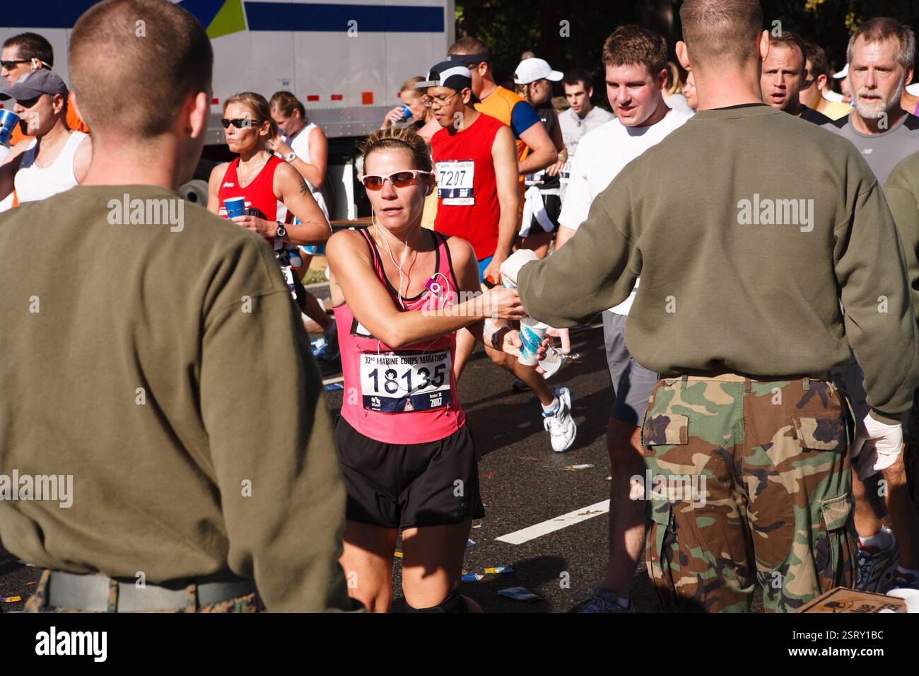 United States Marine Corps personnel hand out water during the Marine ...