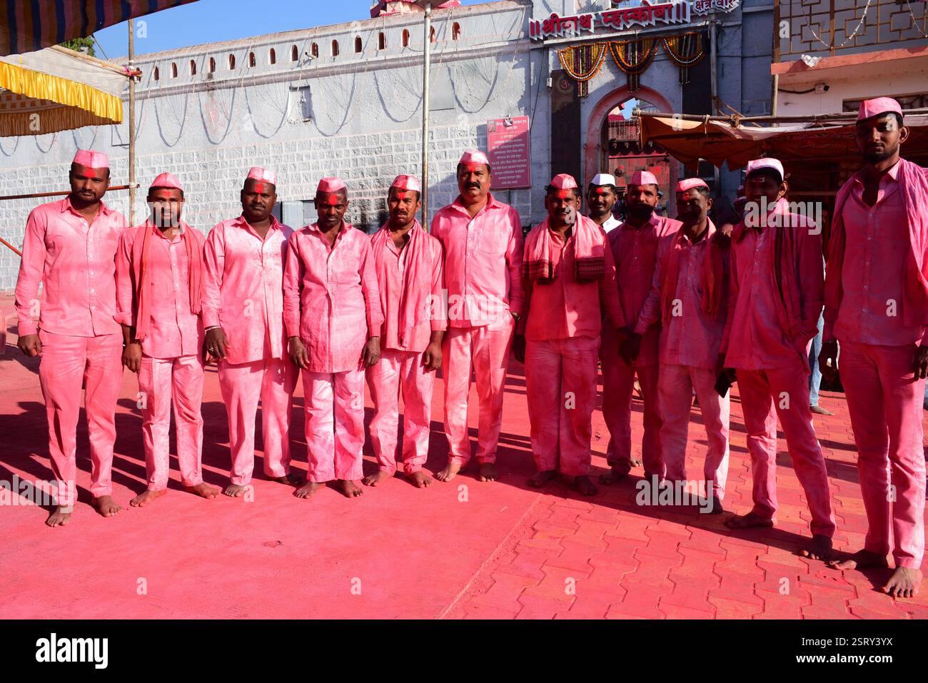 Pilgrims pose for the pictures dressed in red color (Gulal) who are ...