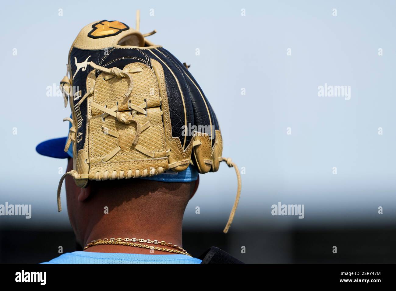 Kansas City Royals relief pitcher Carlos Hernandez wears his glove on his head as he walks to ...