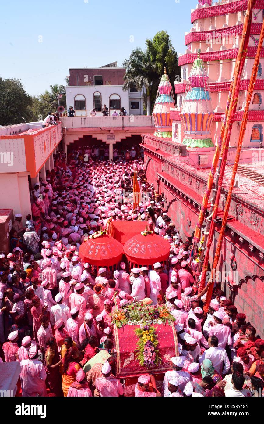 Pilgrims dance on tune of traditional drums dressed in red color (Gulal ...
