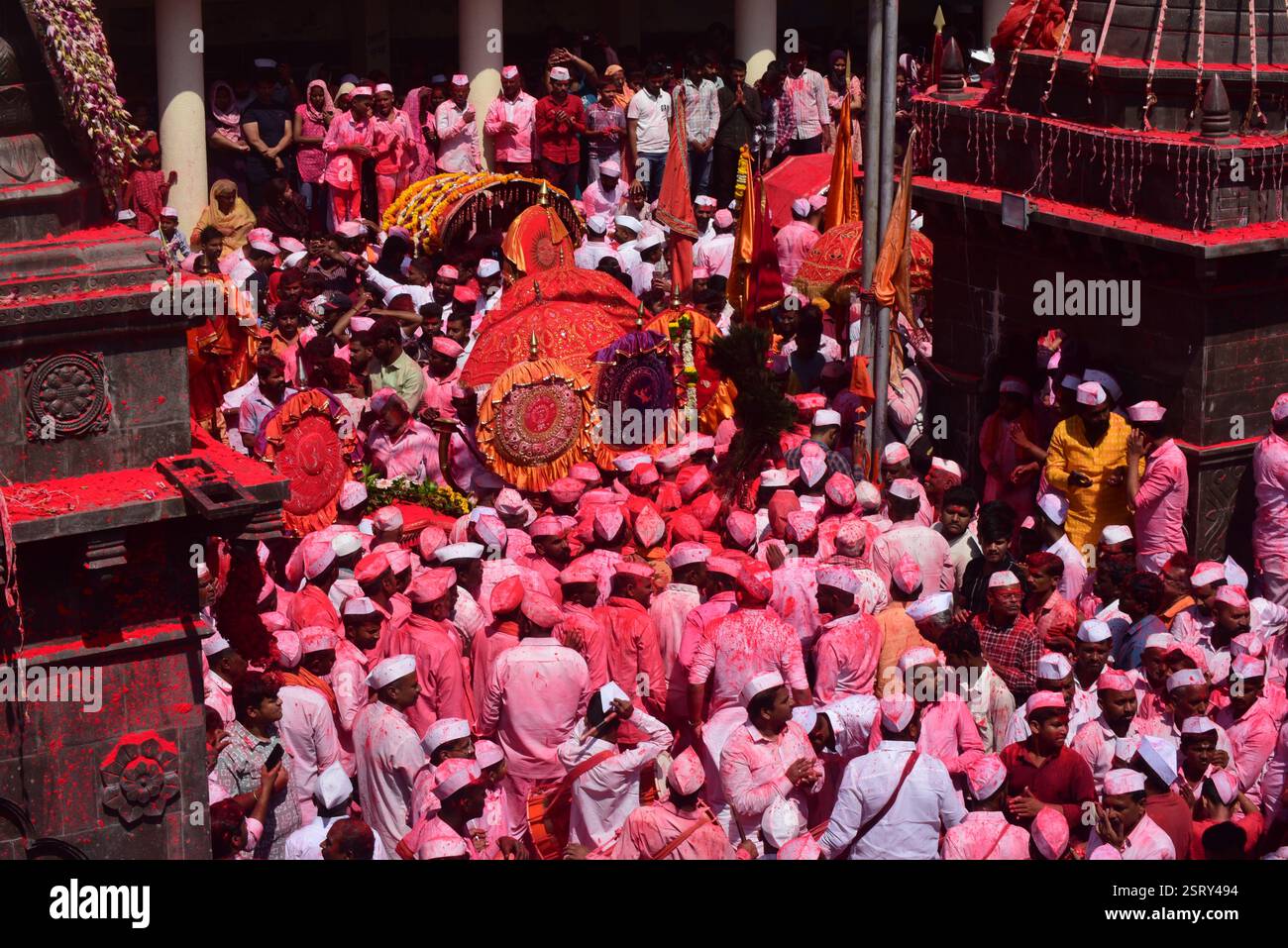 Pilgrims dance on tune of traditional drums dressed in red color (Gulal ...