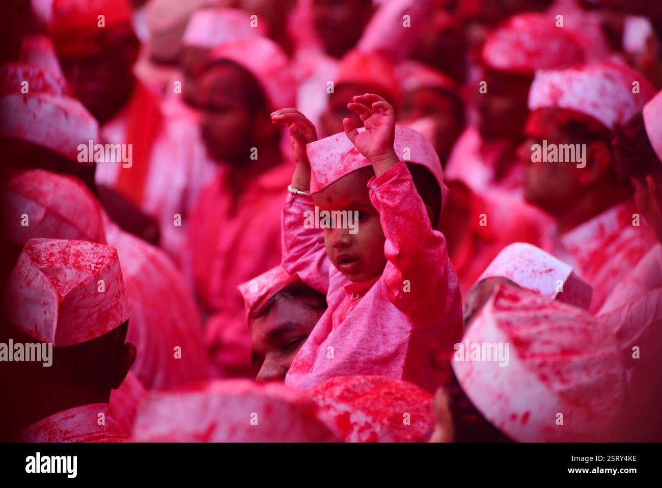 Pilgrims dance on tune of traditional drums dressed in red color (Gulal ...