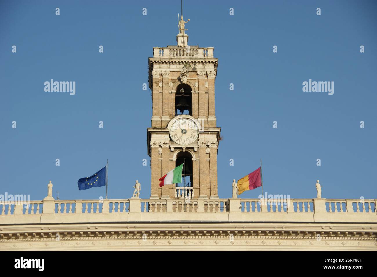 The tower bell of the Senatorial Palace in Rome contrast with a blue ...