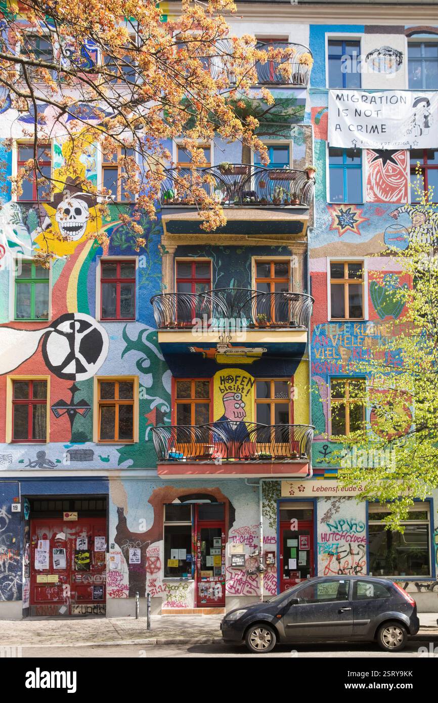 Colorful murals adorn a building on a street in Berlin, Germany. A ...