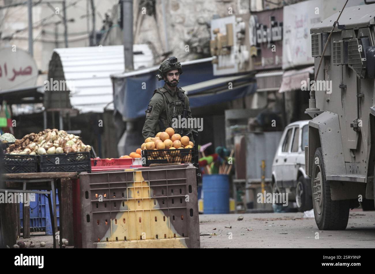 Nablus, Palestine. 16th Feb, 2025. An Israeli soldier takes position in ...
