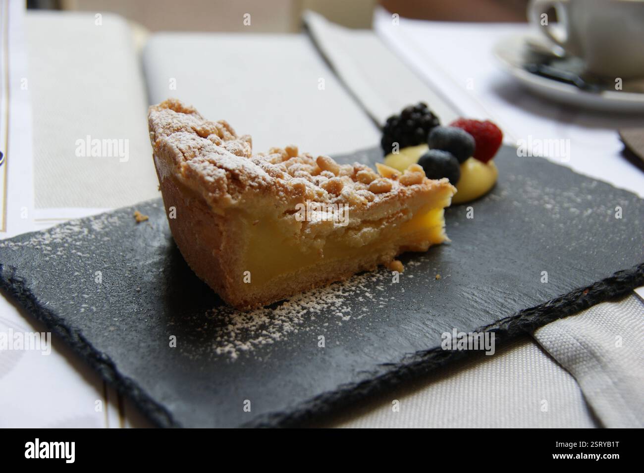 A close-up picture of a slice of Torta della Nonna cake, a traditional ...