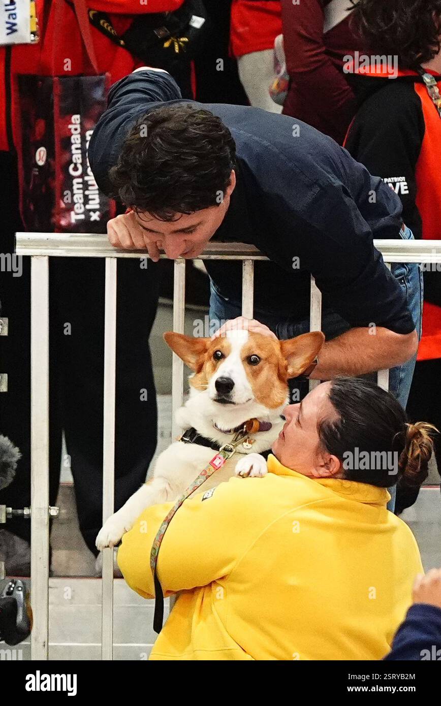 Prime Minister of Canada Justin Trudeau pets a dog in the crowd as he ...