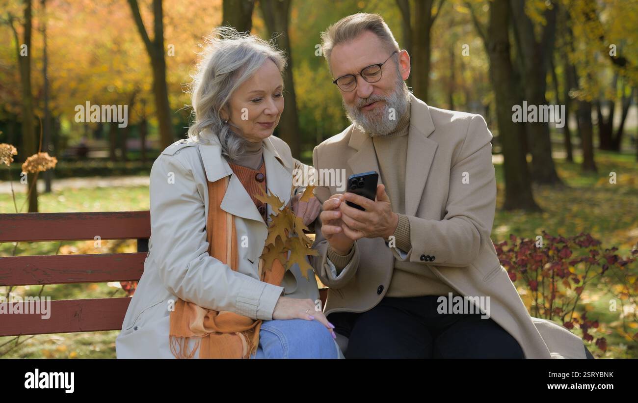 Caucasian retired couple family in love mature woman man sit on bench ...