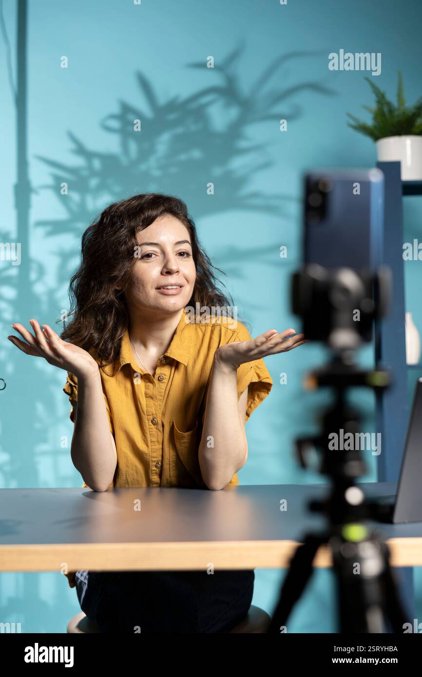 Joyful woman filming vlog with high tech gear in professional studio ...