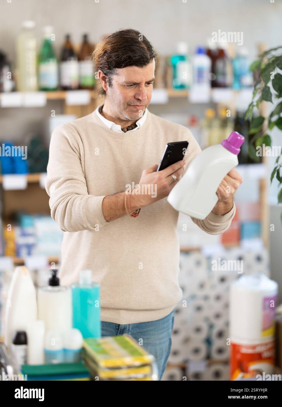 Man scanning barcode of cleansers Stock Photo - Alamy