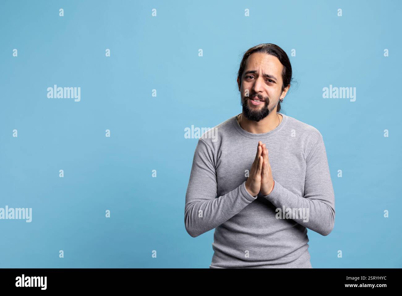 Religious person praying and begging for forgiveness in front of camera ...