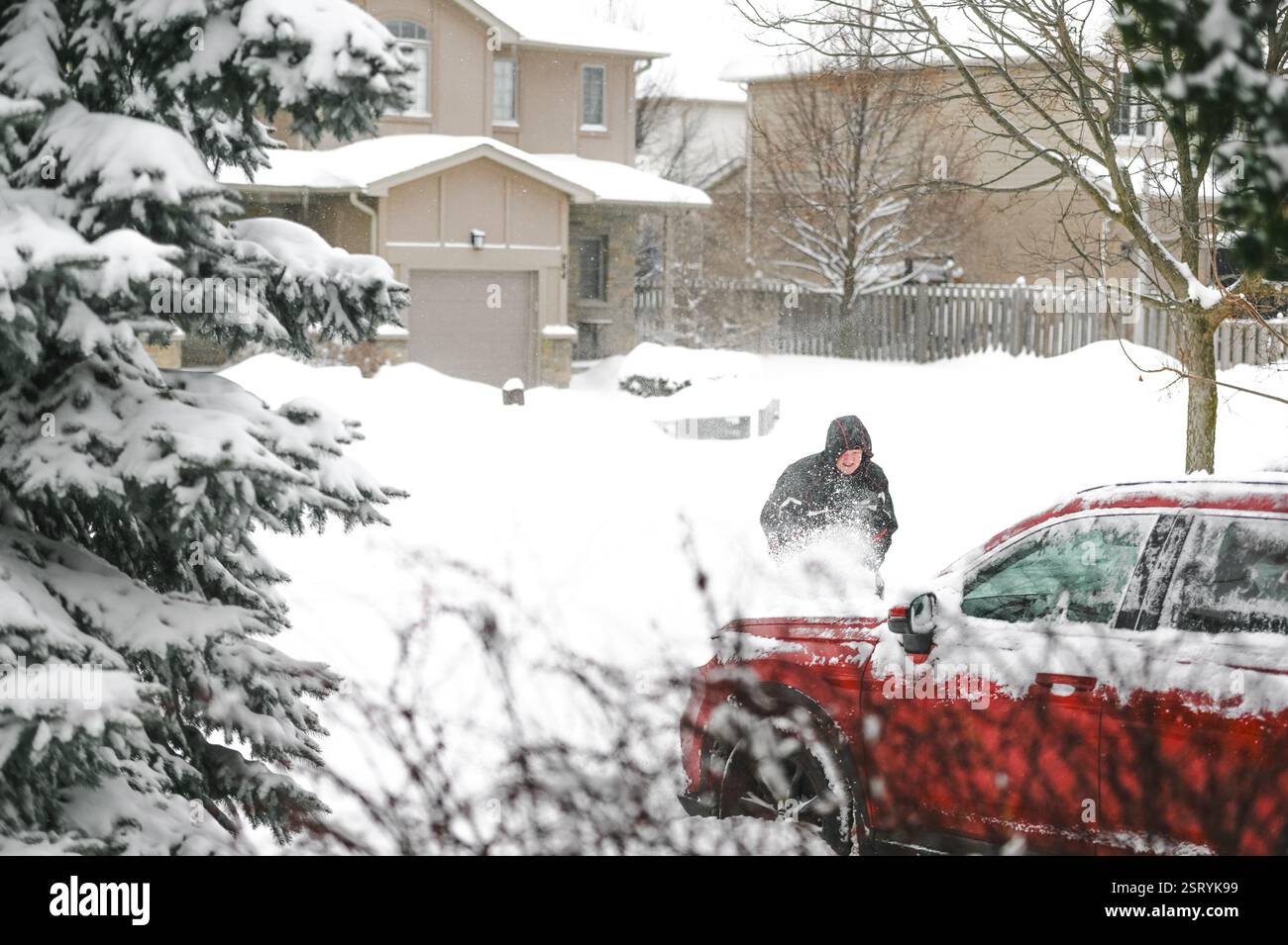 winter snow storm clean up - a man uses the snow blower to move snow ...