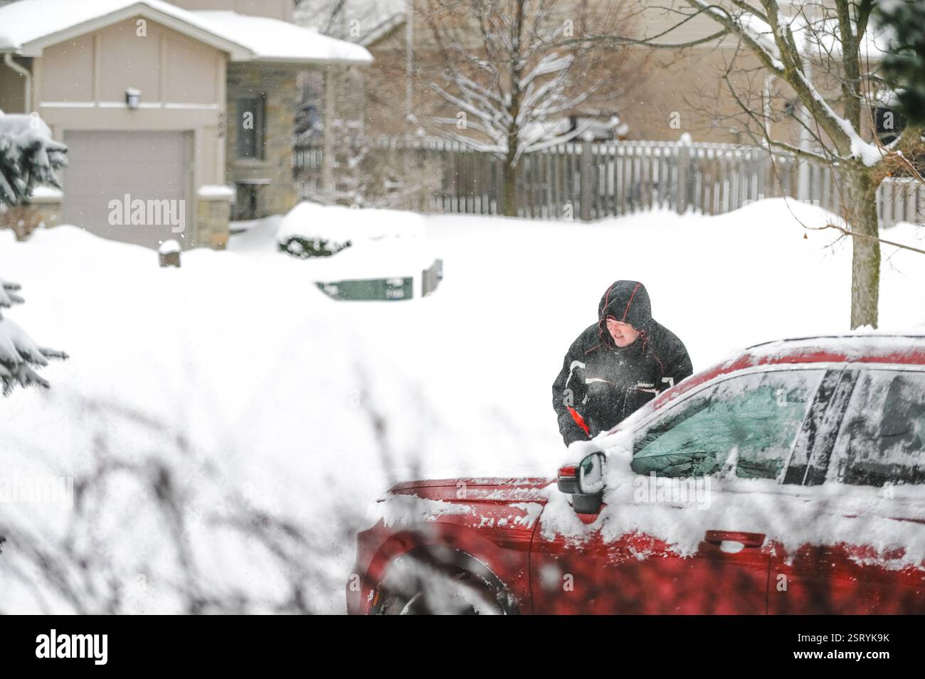 winter snow storm clean up - a man uses the snow blower to move snow ...