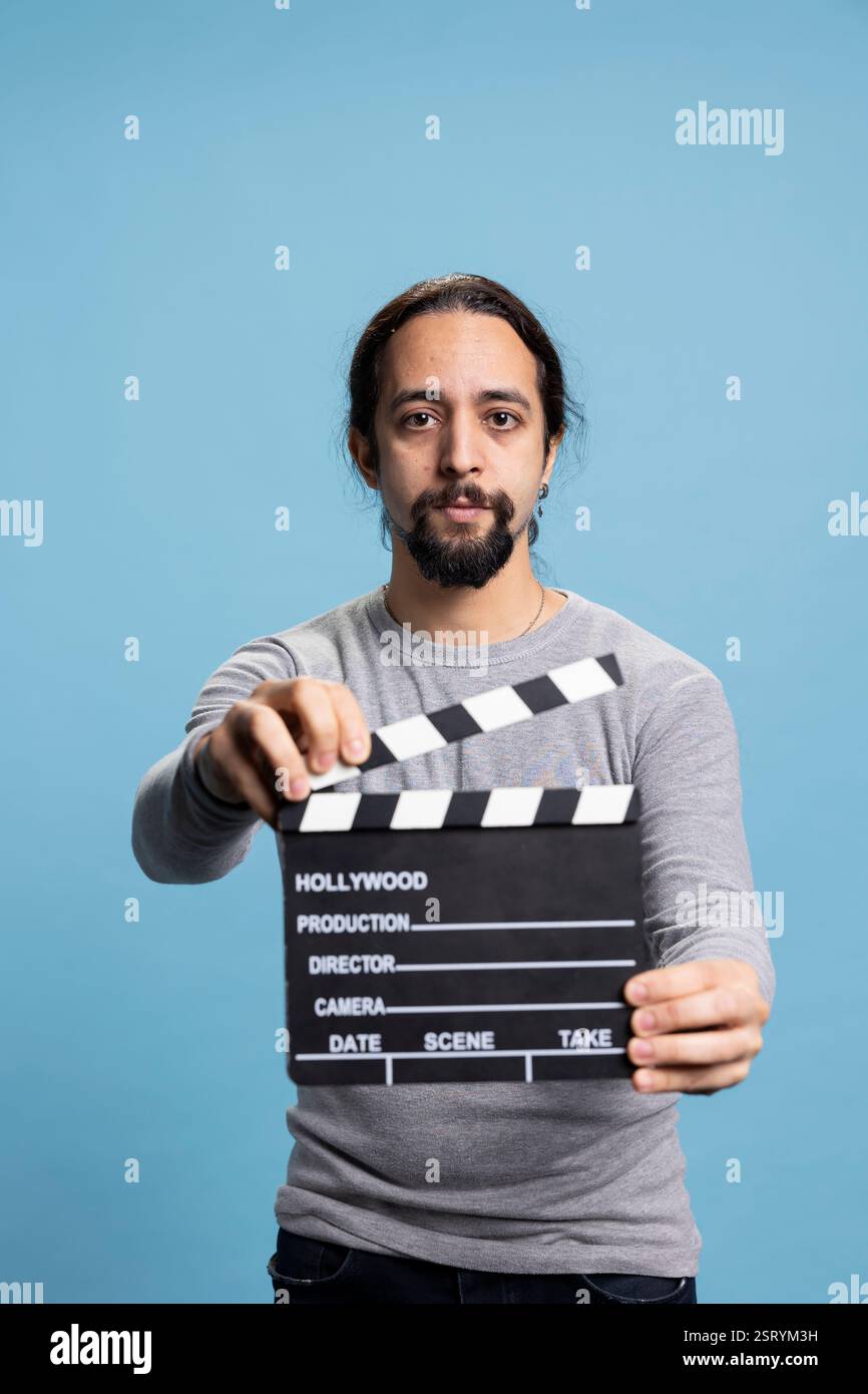 Middle eastern guy holding a filming slate movie production to cut a ...