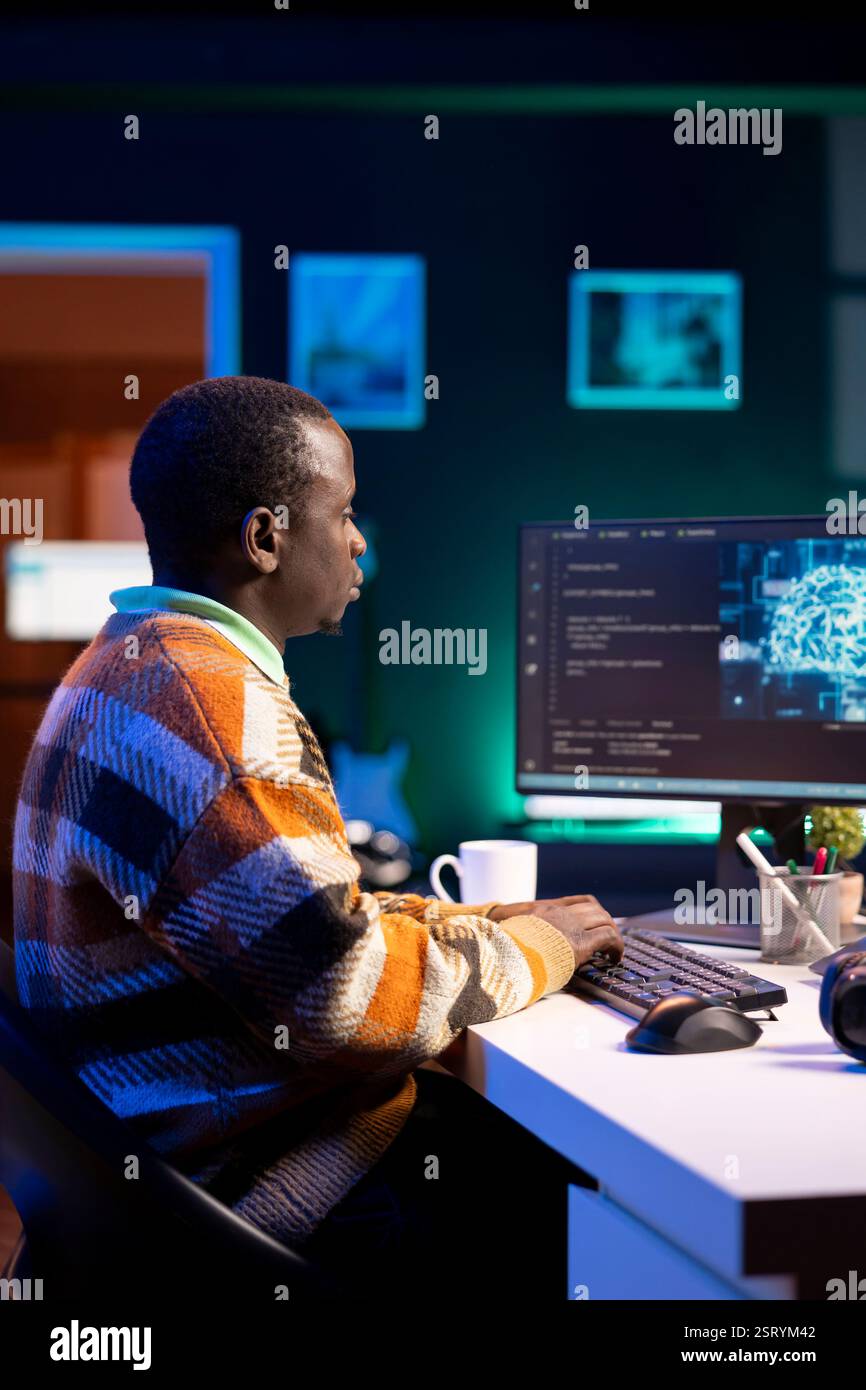 African american IT professional managing AI system for machine ...