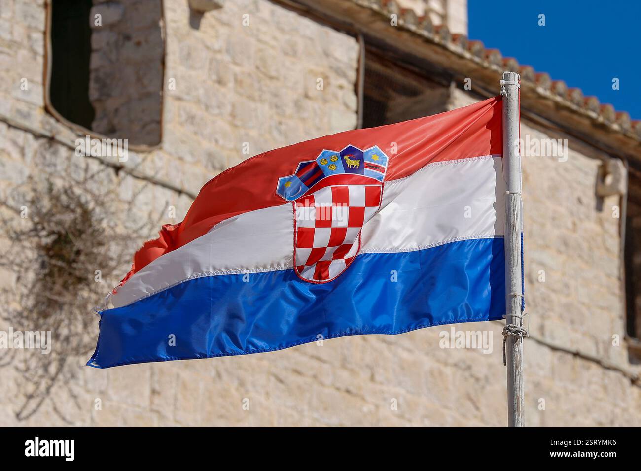 Croatian flag waving in the wind in front of the wall of medieval ...