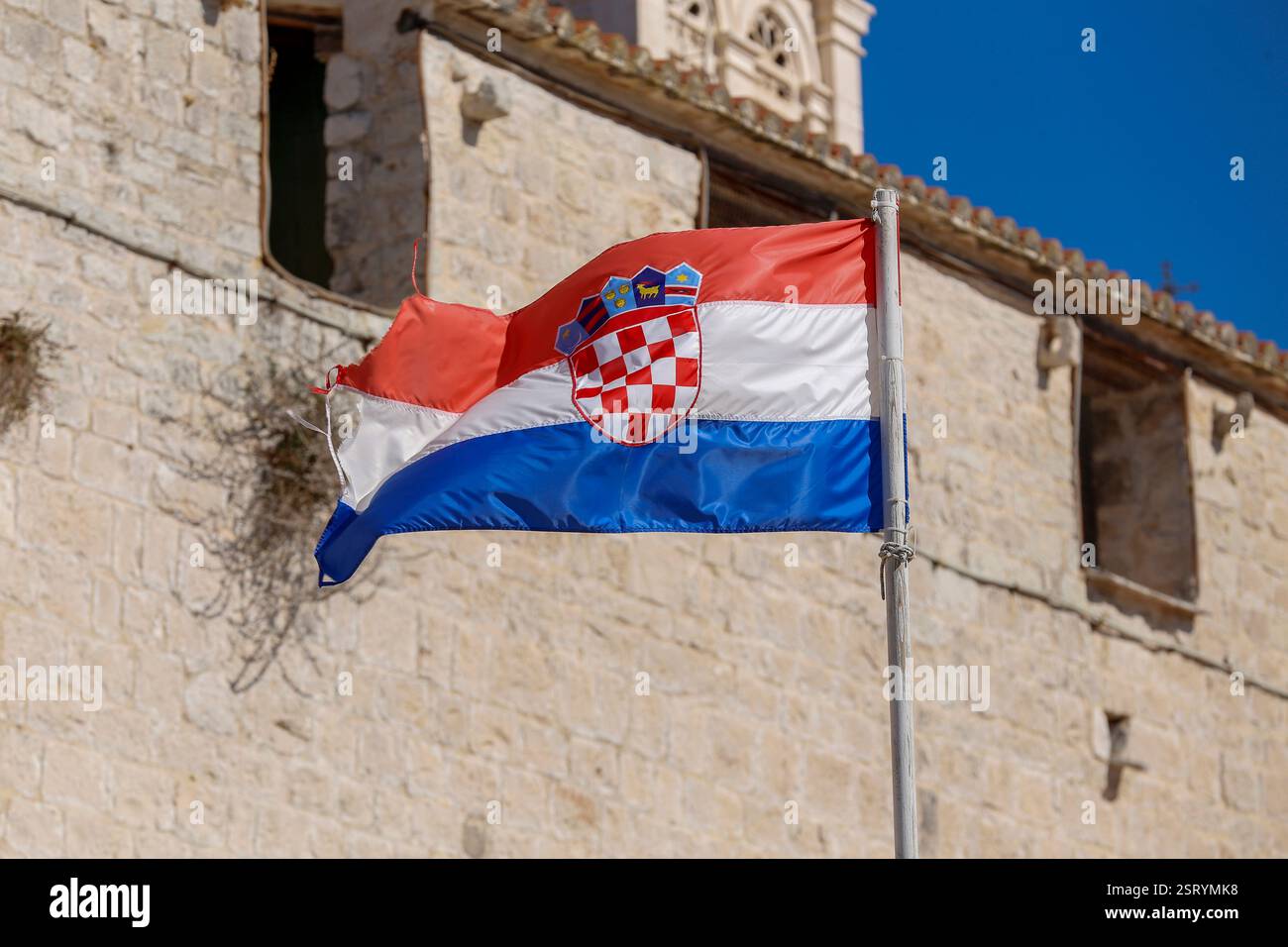 Croatian flag waving in the wind in front of the wall of medieval ...