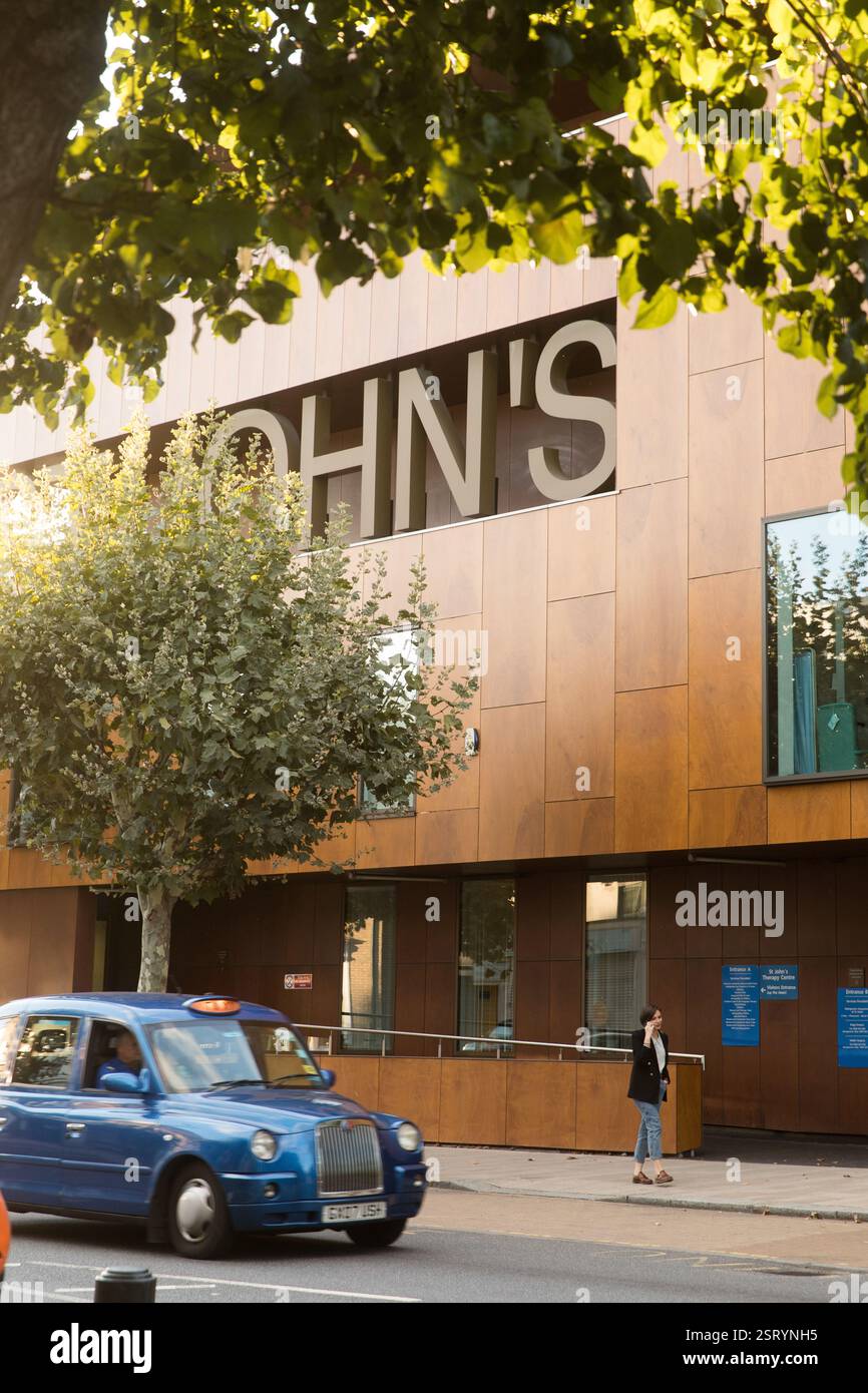 Blue taxi passes The Haider Practice St John's Hill, London, UK ...