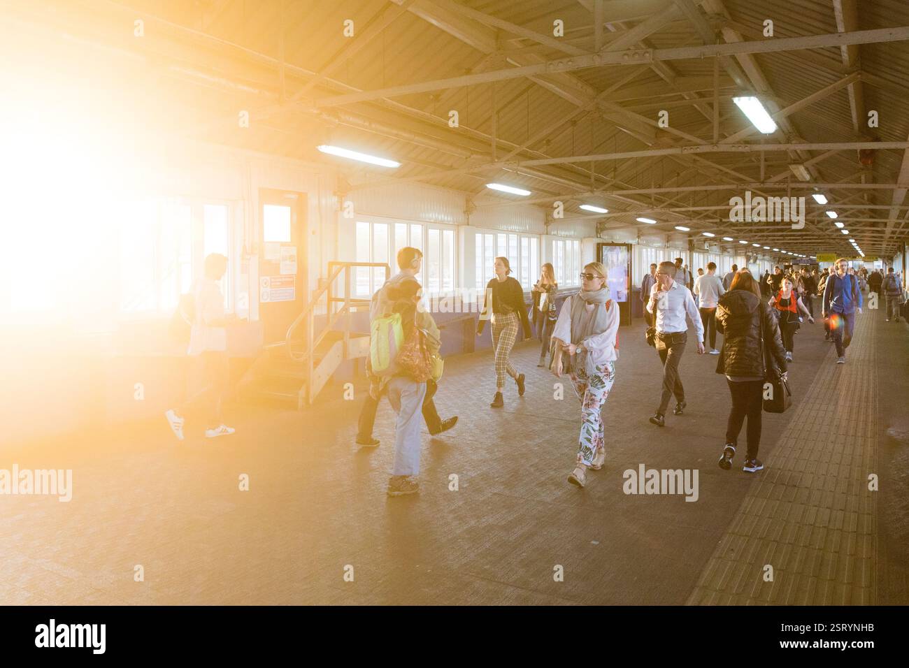 Pedestrians walk the elevated walkway at Clapham Junction station ...