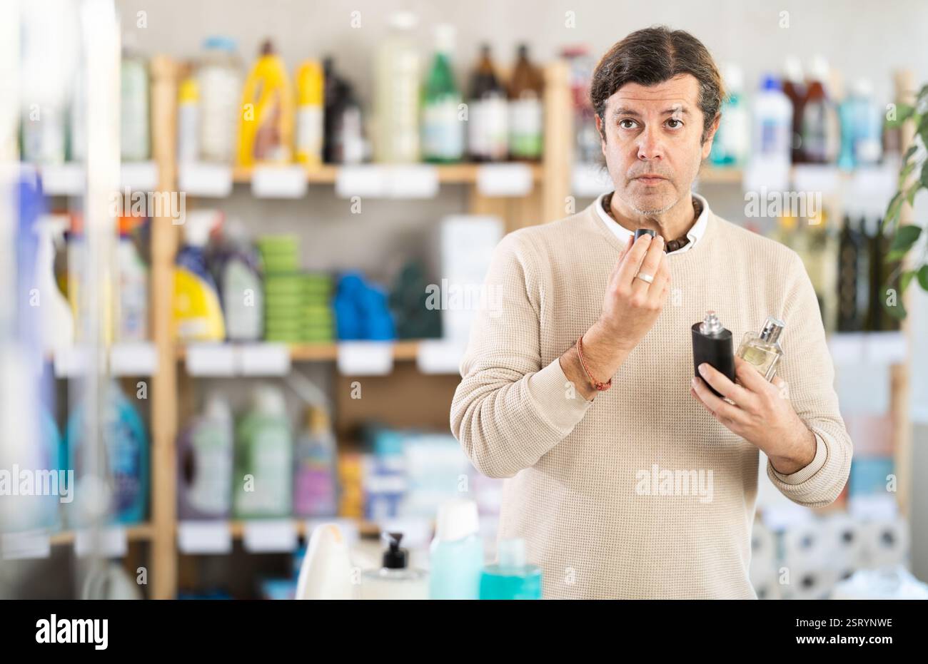 customer chooses perfume in the store Stock Photo - Alamy