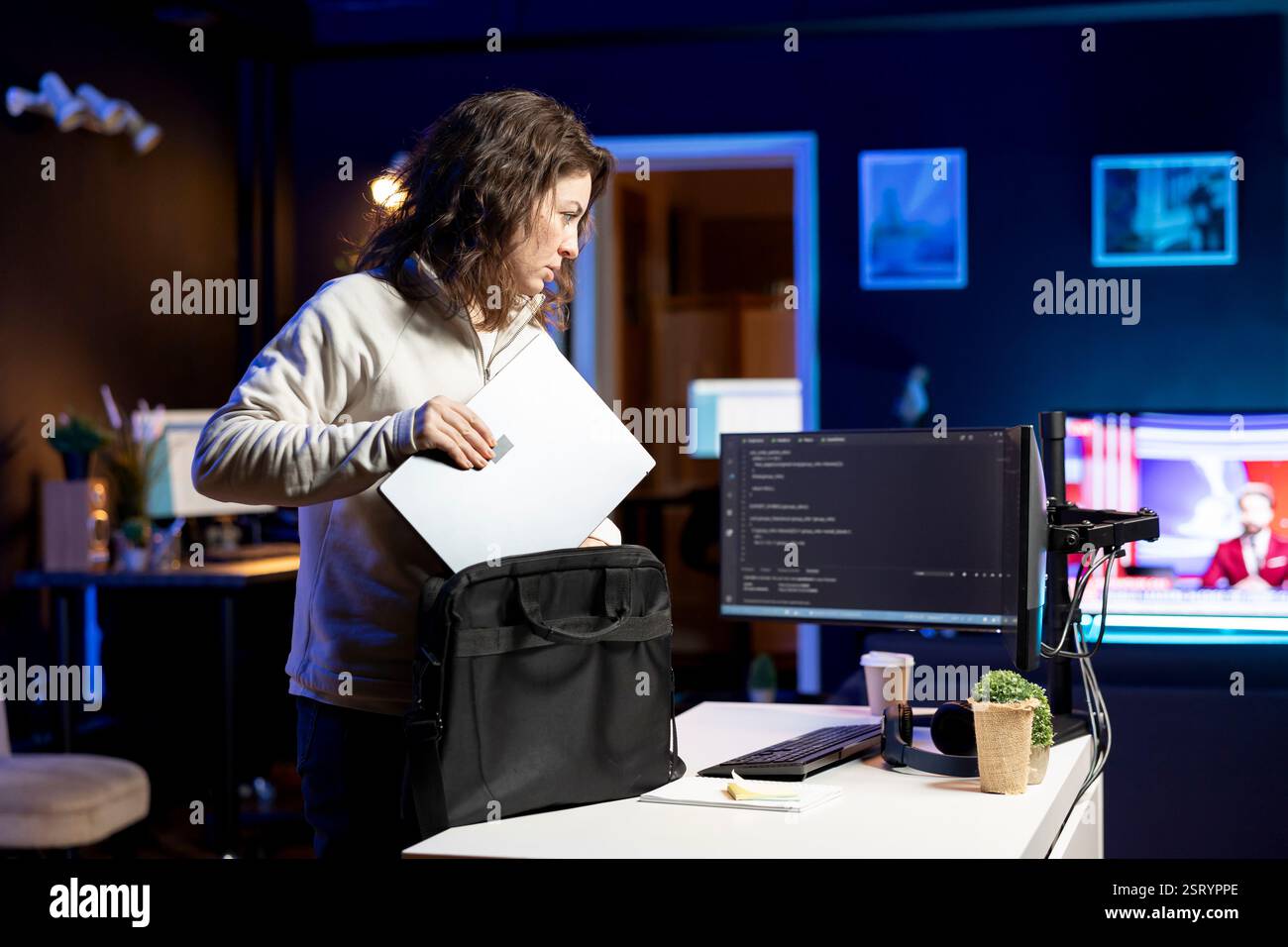 Woman Packing Laptop After Finishing Doing Software Quality Assurance