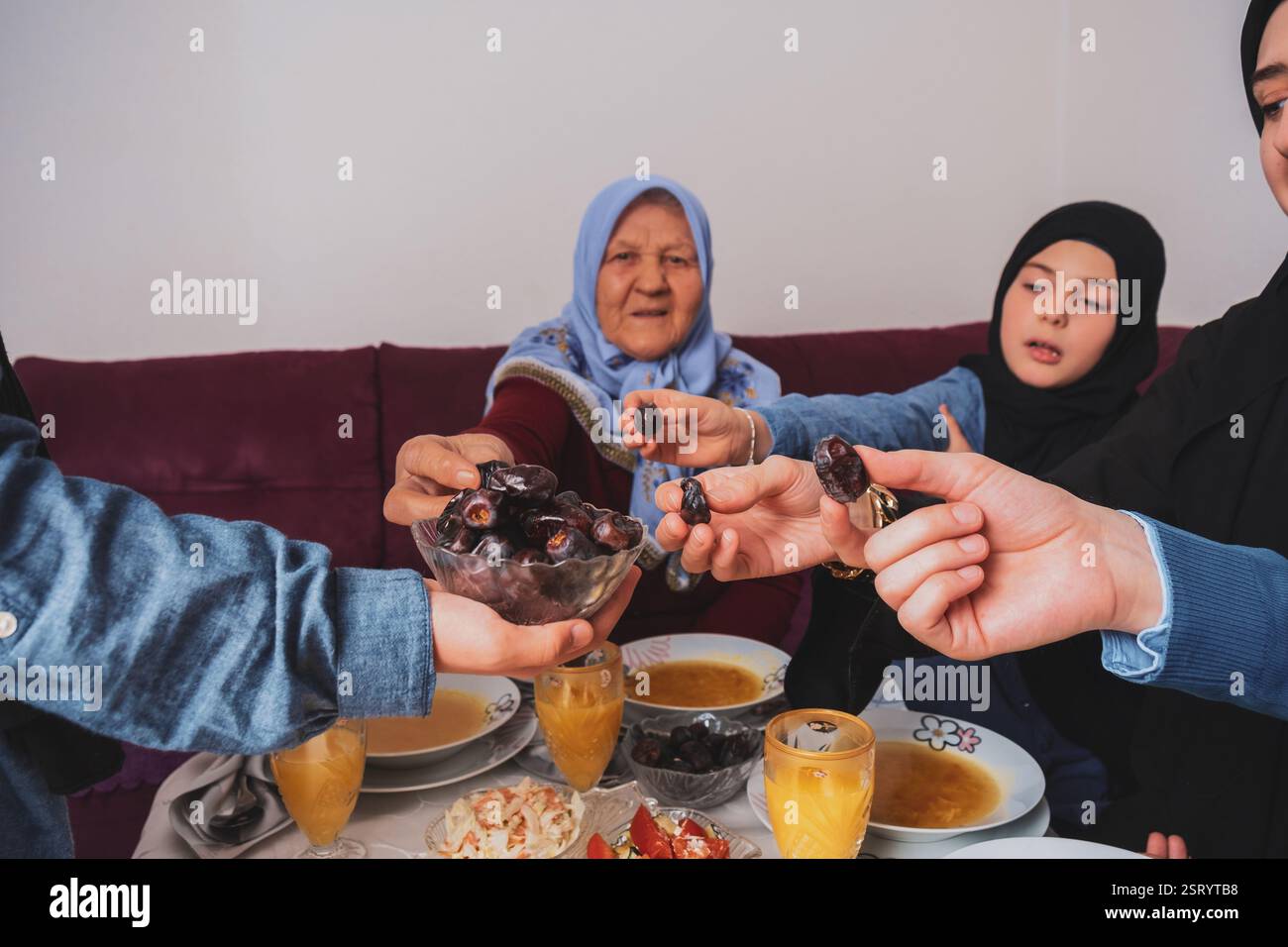 Happy Muslim family having iftar dinner at home during Ramadan dining ...